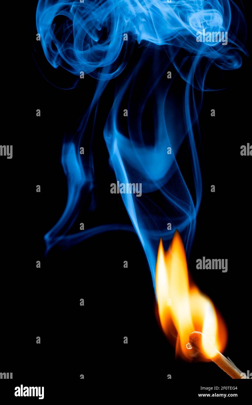 Burning match with blue smoke, black background, studio Stock Photo - Alamy