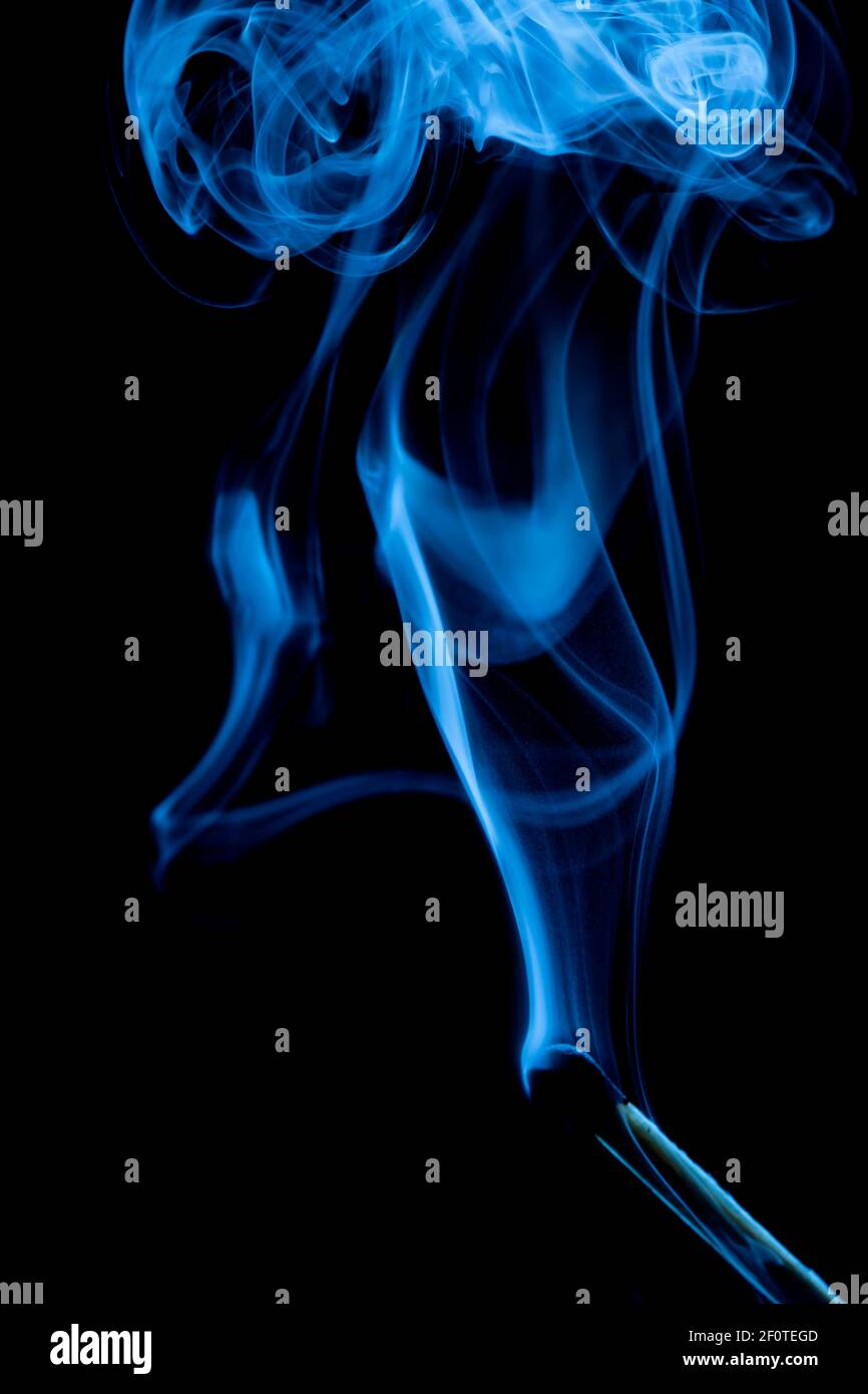 Extinguished match with blue smoke, black background, studio Stock ...
