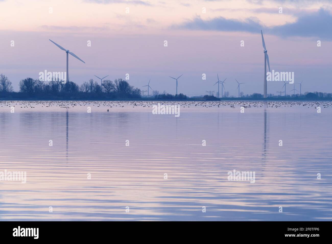 Lake with two Bladed Wind Turbines, or modern Windmills, in a Wind Farm ...