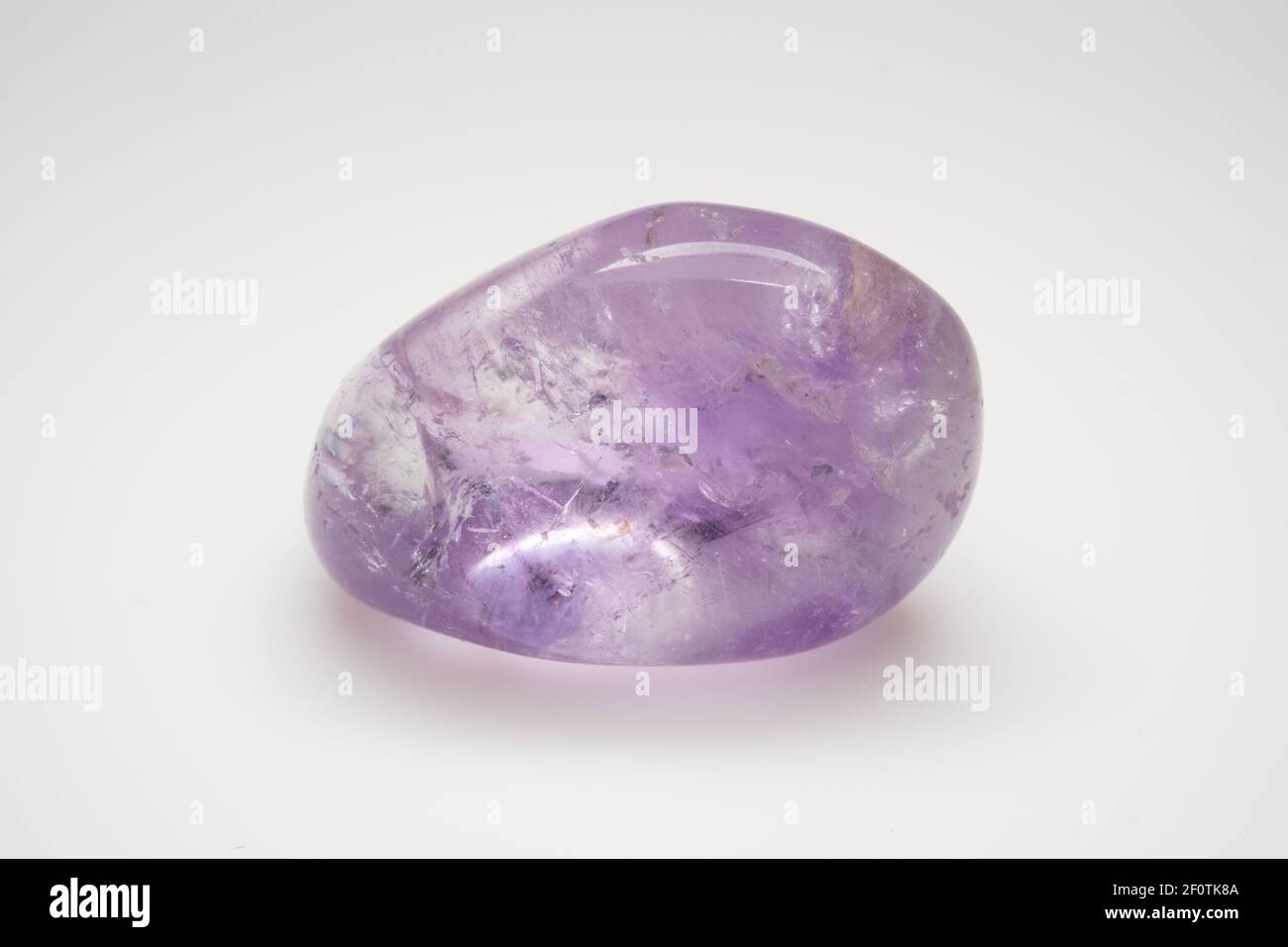 Natural stone amethyst on white background Stock Photo - Alamy