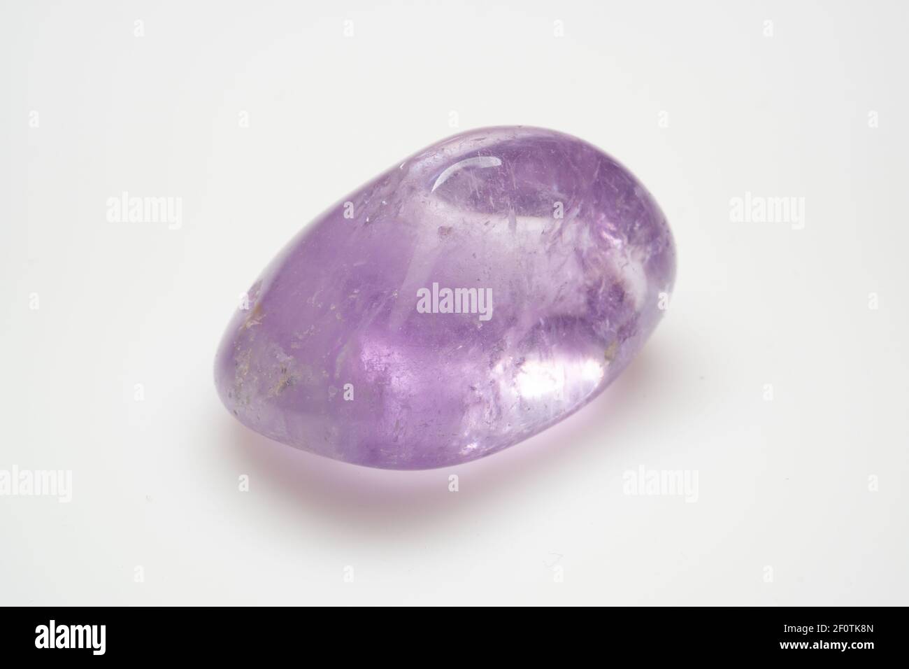 Natural stone amethyst on white background Stock Photo - Alamy
