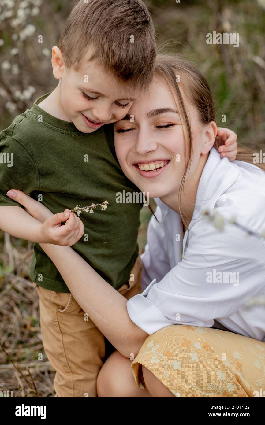 Happy Mother And Son Having Fun Together Mother Gently Hugs Her Son