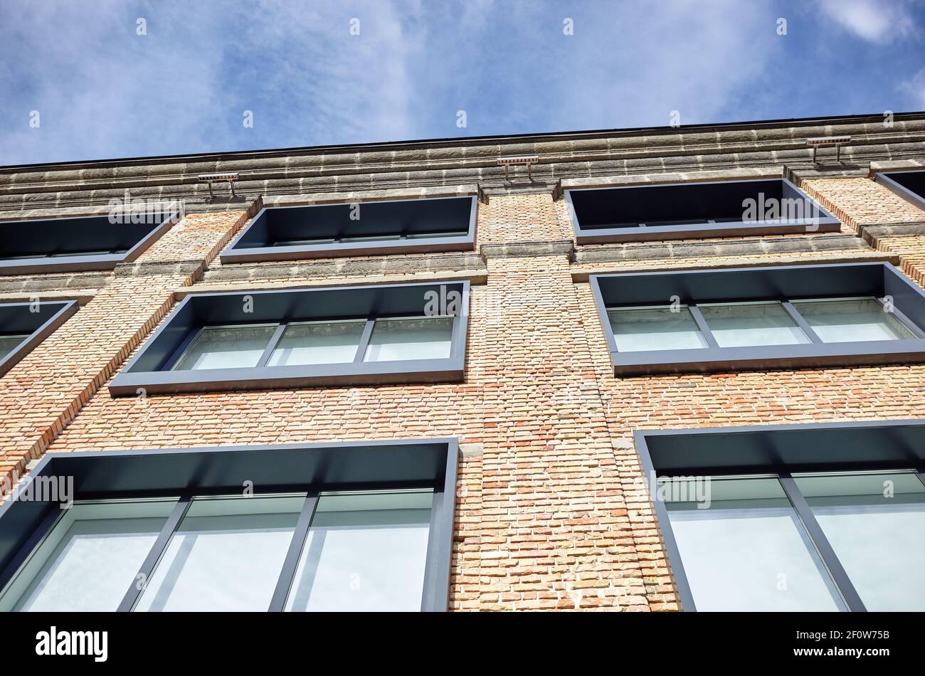 Facade of old factory building. Brick building with windows and ...