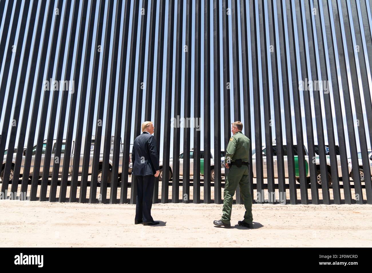 President Donald Trump walks along the completed 200th mile of new ...