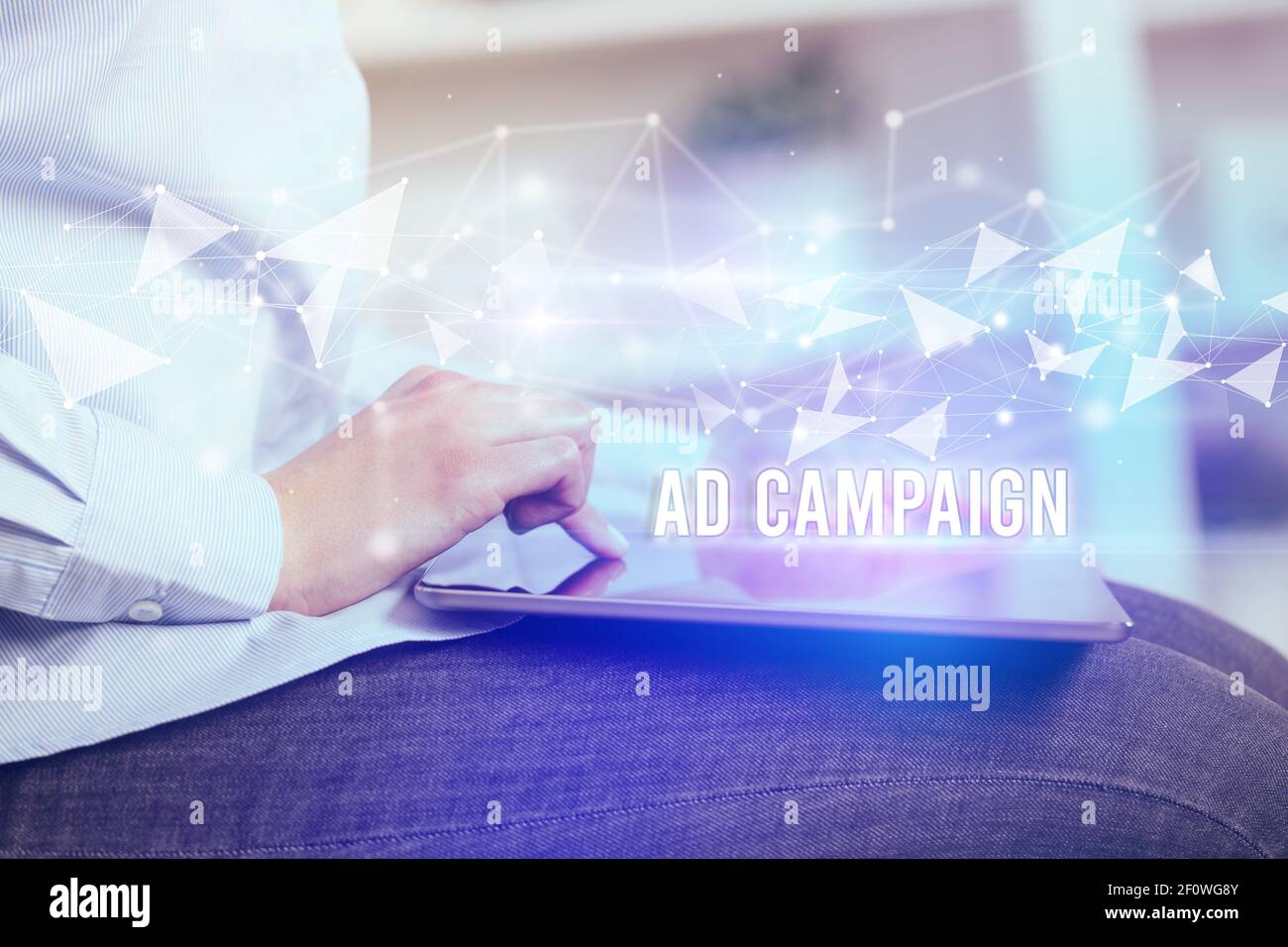 Close up hands using tablet with AD CAMPAIGN inscription, modern ...