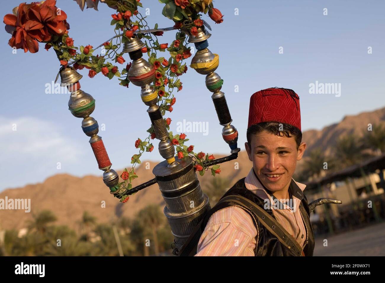 April 2008- Aqaba, Jordan- A young boy sells tamarind juice from a ...