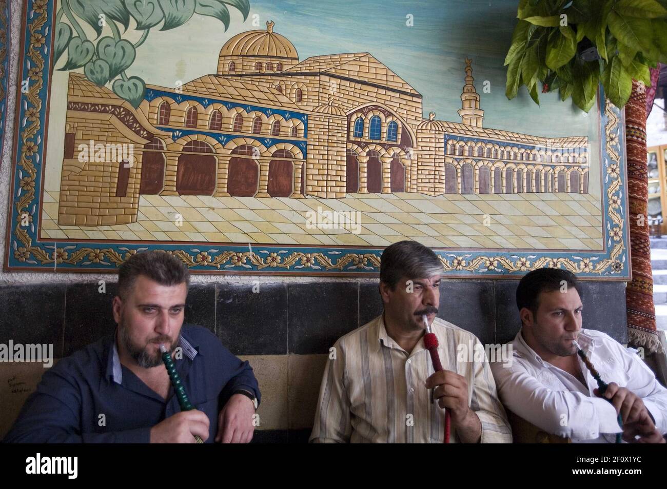 May 2008- Damascus, Syria- Men smoke nargileh at a tea house in the Old ...