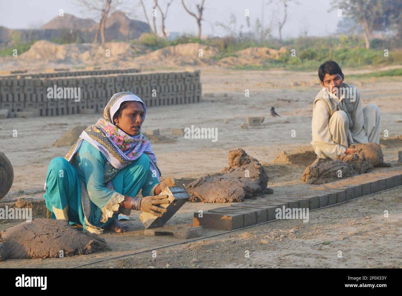 Lahore, Pakistan. 02nd Mar, 2021. Pakistani female labourer makes clay ...