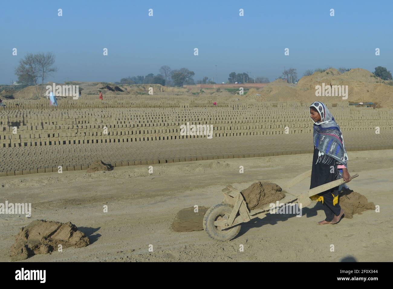 Lahore, Pakistan. 02nd Mar, 2021. Pakistani female labourer makes clay ...