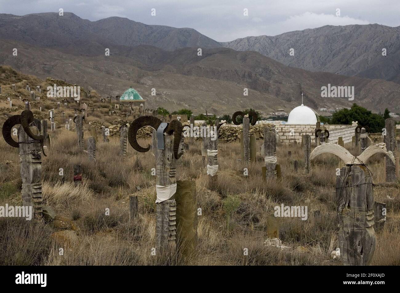 June 2008- Nokhur, Turkmenistan- Wild goat horns mark the graves at a ...