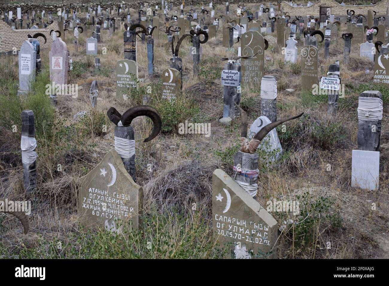 June 2008- Nokhur, Turkmenistan- Wild goat horns mark the graves at a ...
