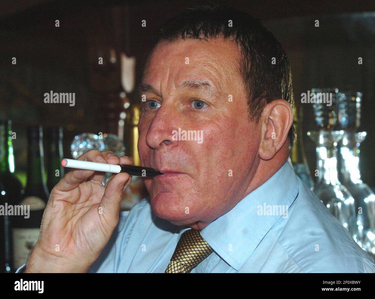 THE FIRST ELECTRIC CIGARETTE. BUSINESSMAN GREG CARSON WITH HIS ELECTRIC ...
