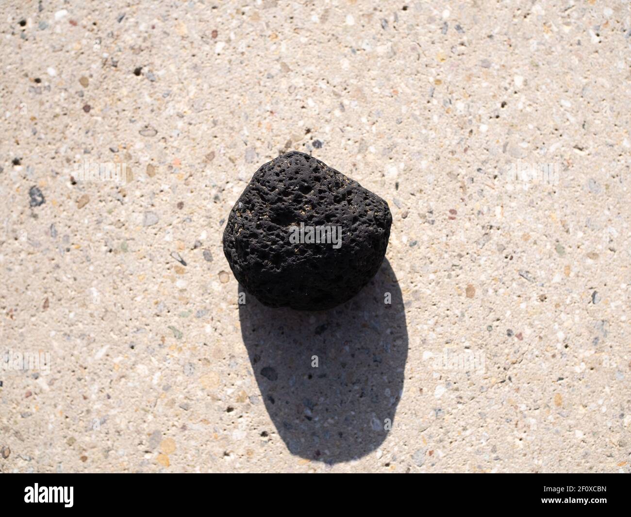 Volcanic stone on concrete surface Stock Photo - Alamy