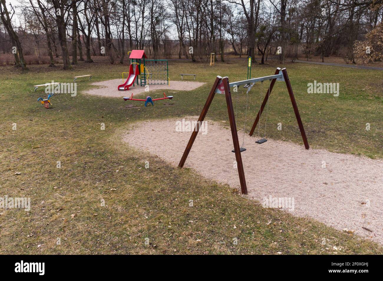 Lonely swing and slide at empty children playground Stock Photo - Alamy
