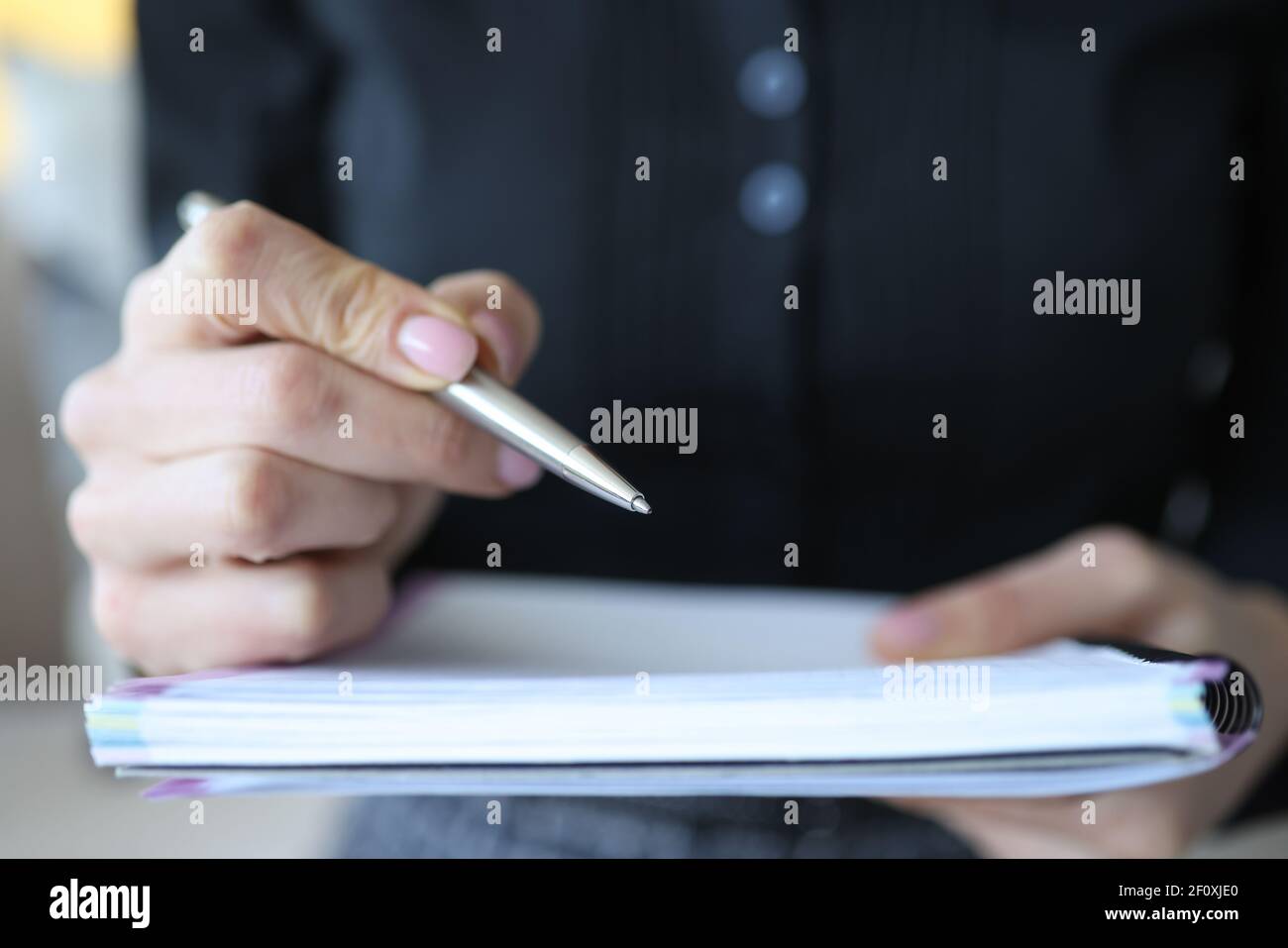 Female hand makes notes with pen in notebook Stock Photo - Alamy
