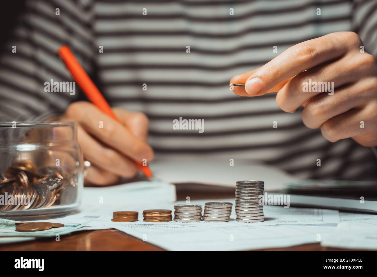 male businessman calculating stacking coin saving money for home ...