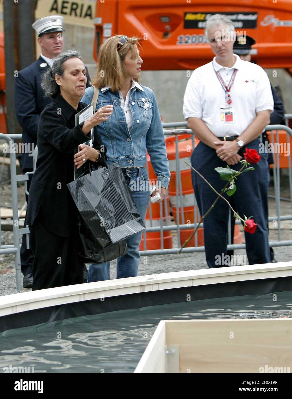 11 September 2008 - New York, NY - Family members toss roses into the ...