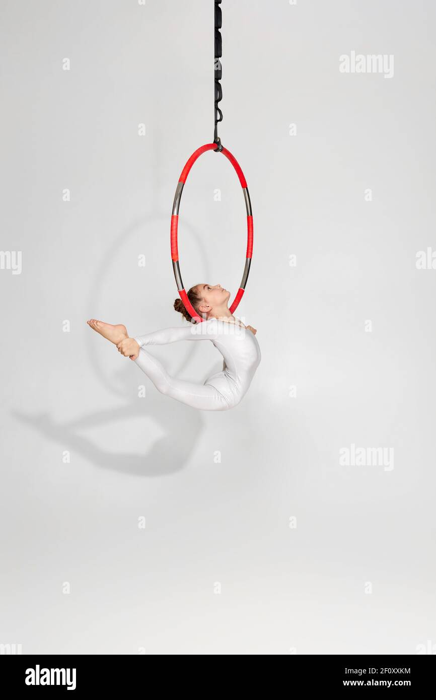 graceful little child girl gymnast in white sportwear doing twine on an ...