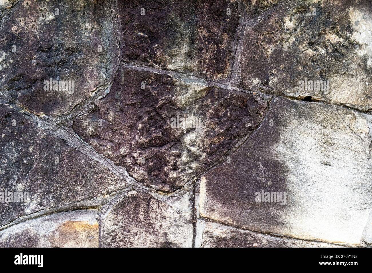 Old rotten stone wall with weathered seams. Abstract texture Stock ...