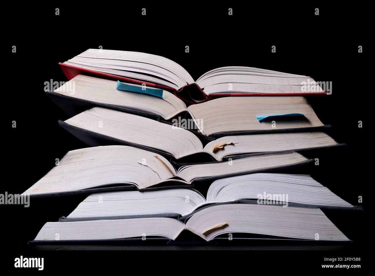 A stack of books on the desk. Old extensive literary publications. Dark ...