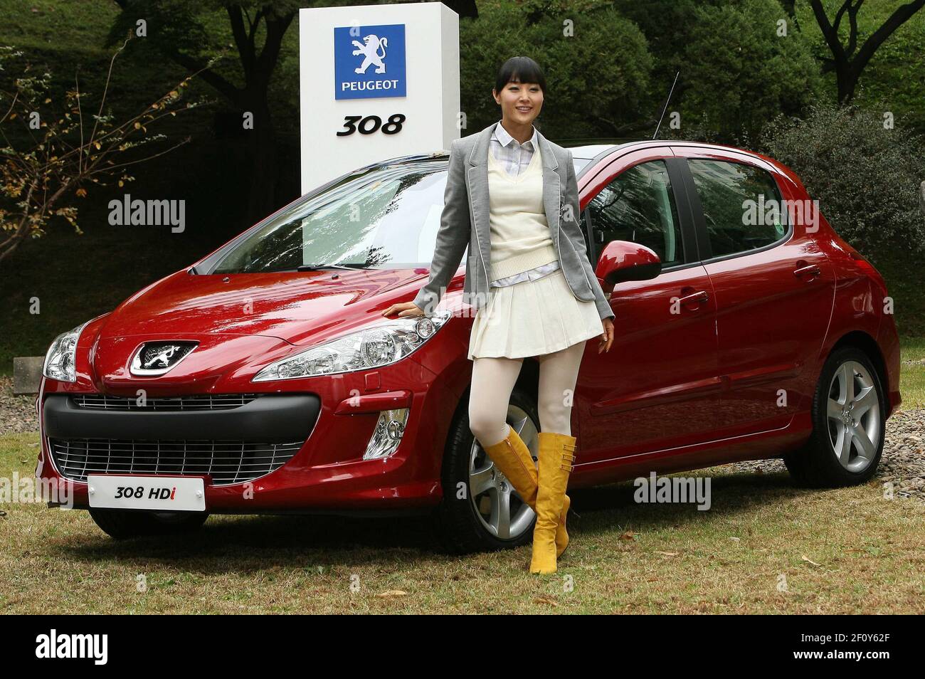 22 October 2008 - Seoul, South Korea - South Korean model poses with the Peugeot 308SW HDi and ...