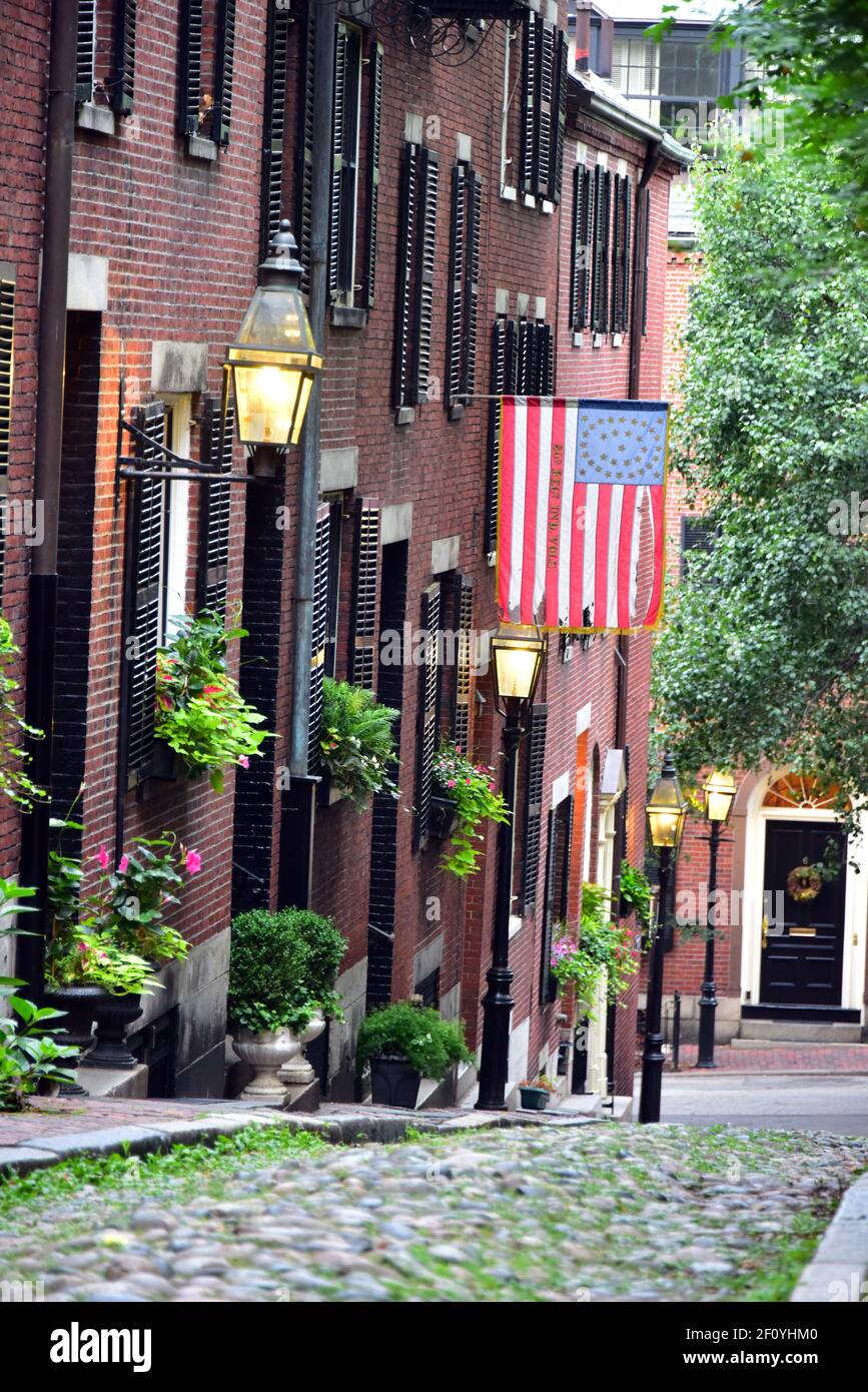 Betsy Ross flag hangs over the colonial house fronts along Acorn St. in ...