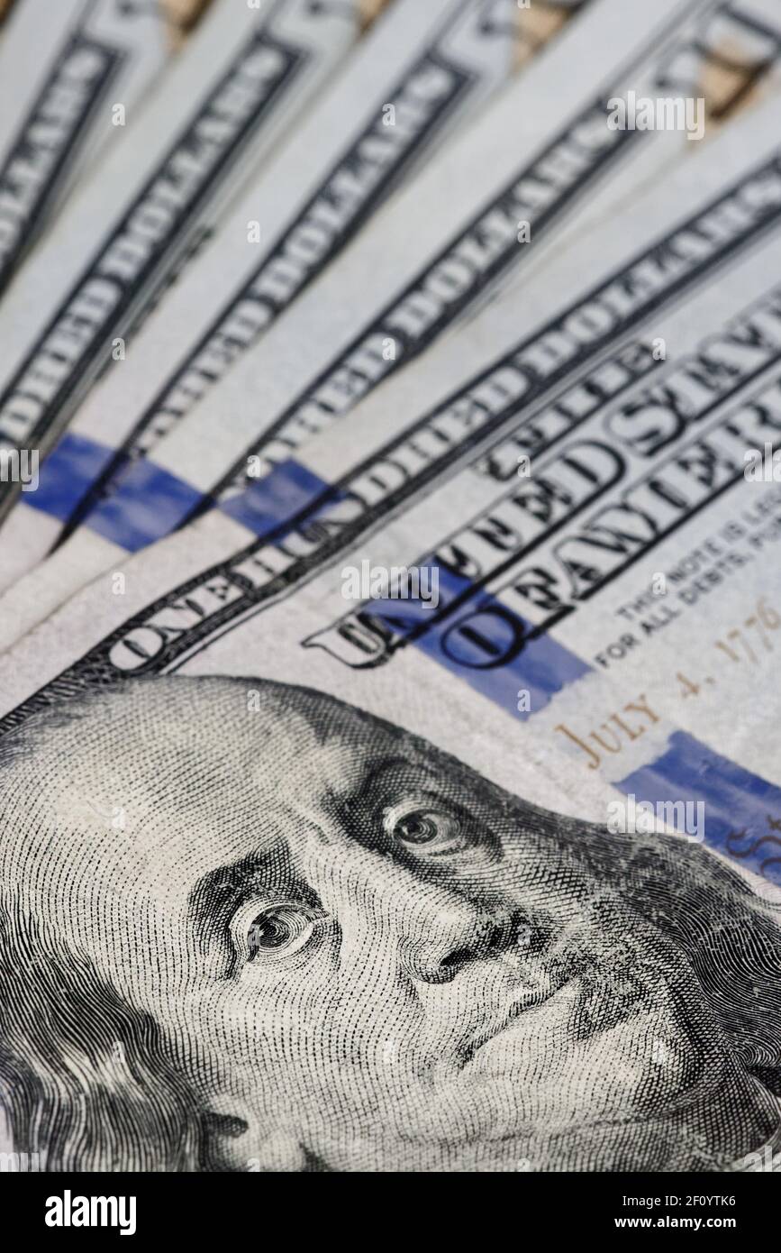 selective focus on fanned out stack of 100 dollar bills with close up ...