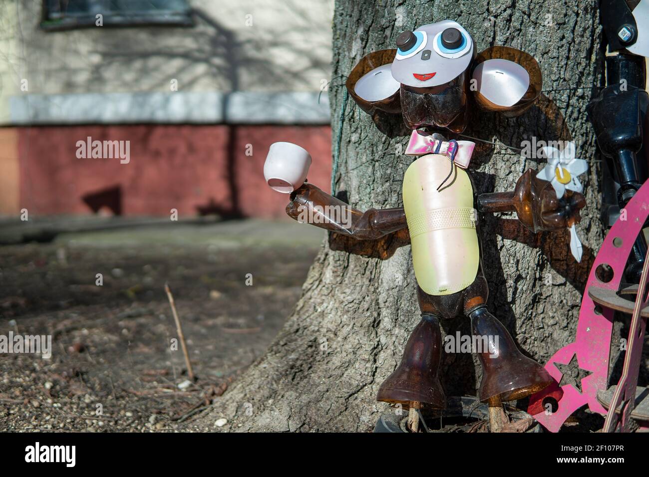 doll made of empty plastic bottles near a tree. plastic recycling ...