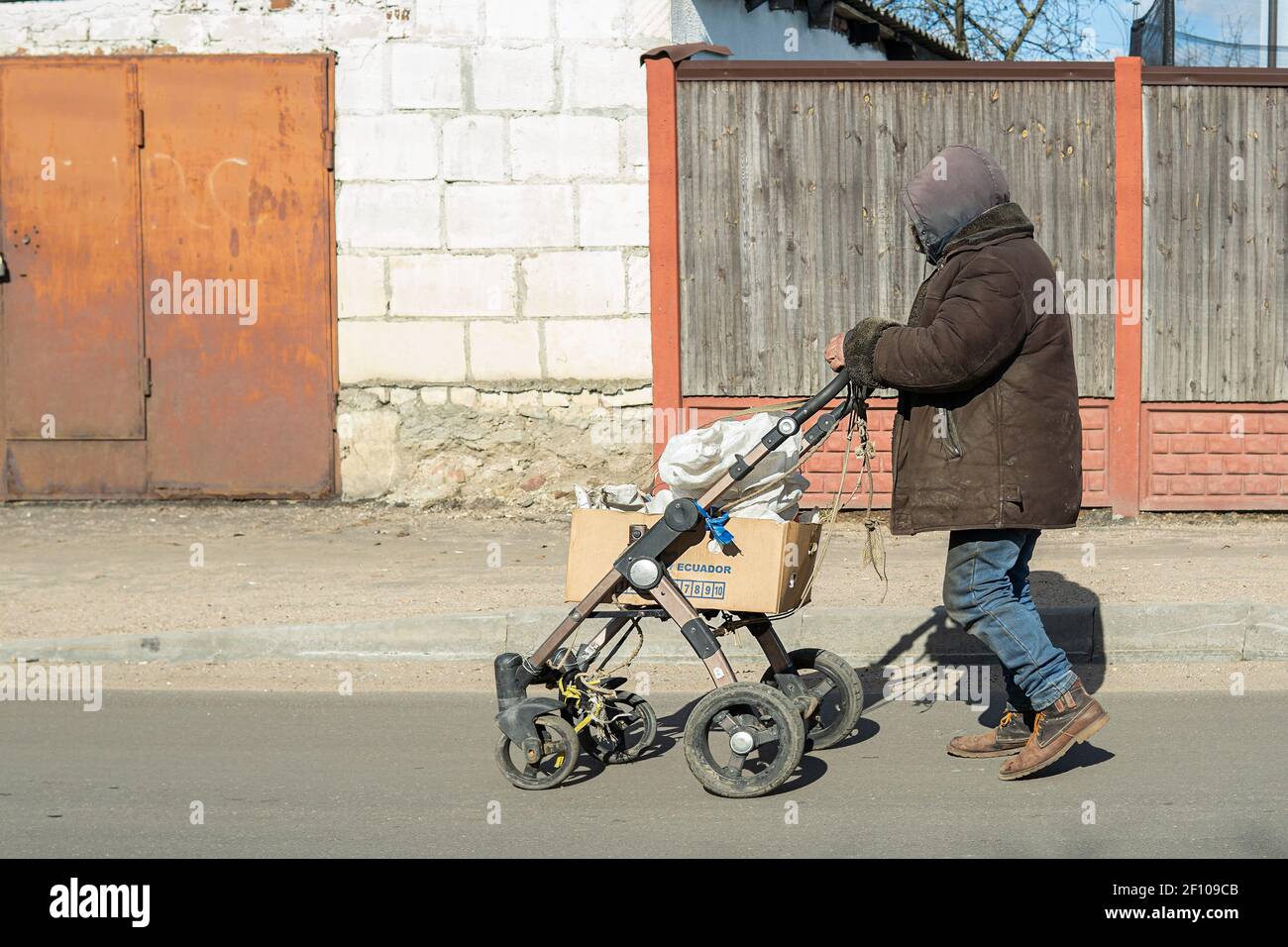 Homeless man walking down the road on a sunny day Stock Photo - Alamy