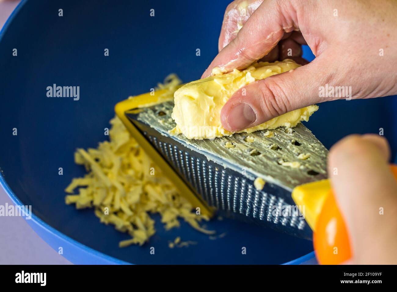 Hand shredded butter with grated Stock Photo - Alamy