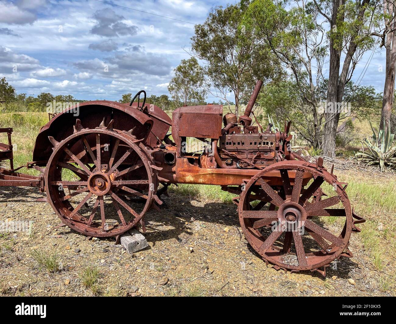 Old rusty agricultural tractor equipment in the field of a farm in ...