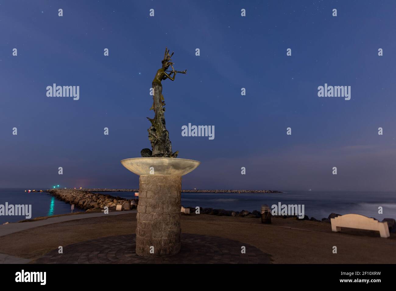 Statue silhouette watching over the Pacific Ocean harbor of Ventura ...