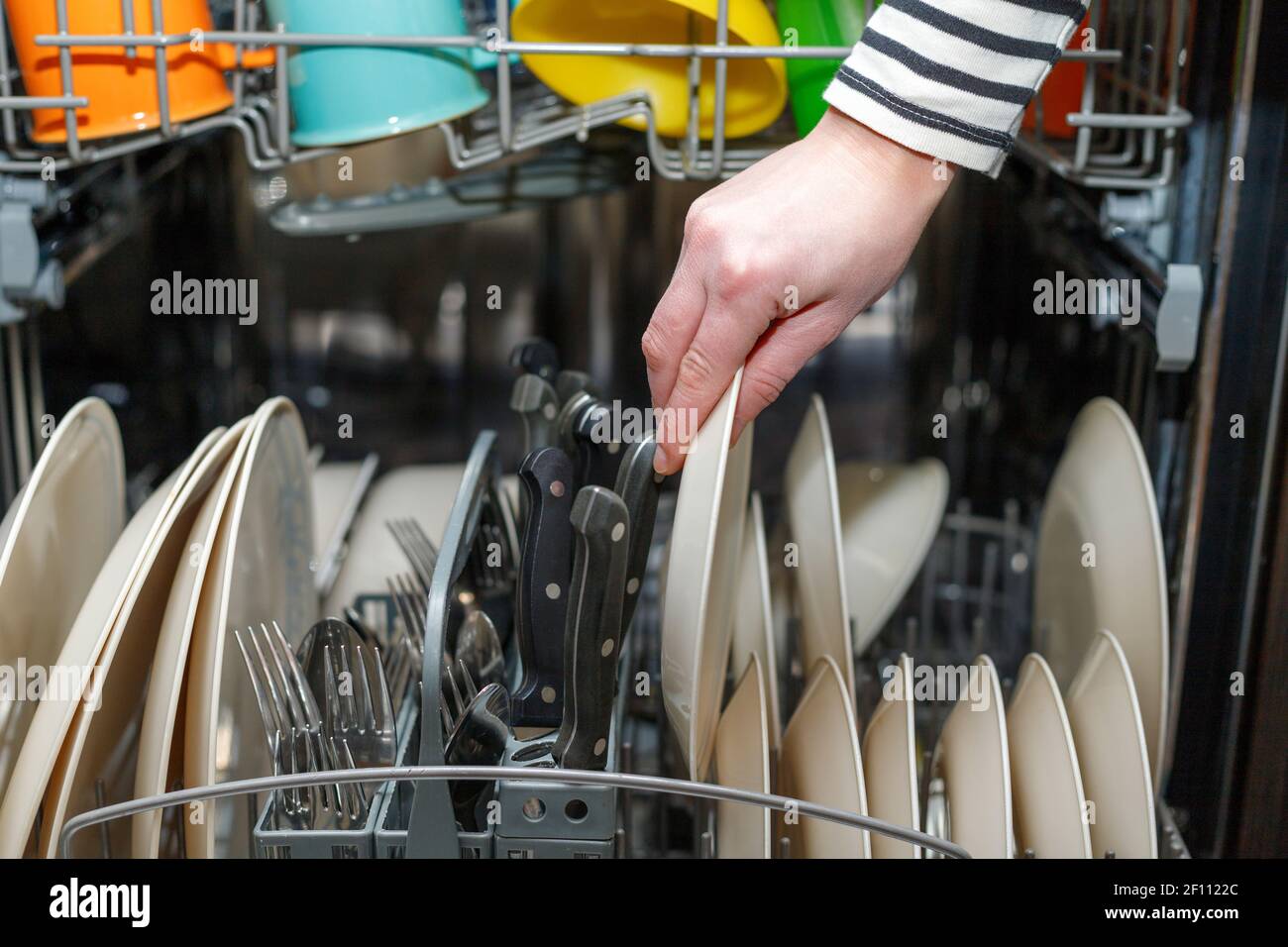 Woman loading dishwasher hi-res stock photography and images - Alamy