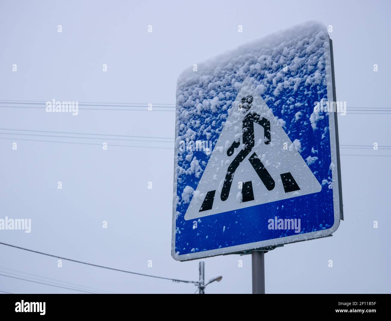Road blue sign in the snow. Crosswalk Stock Photo - Alamy