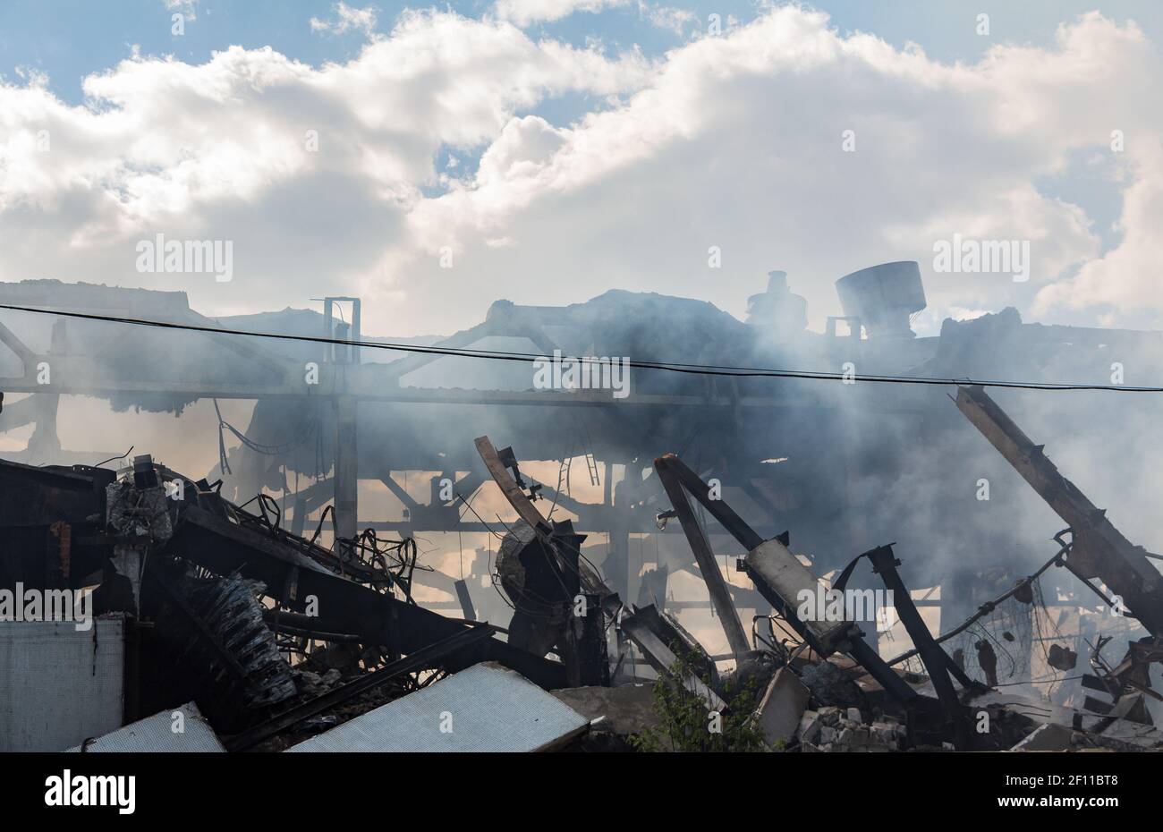 Technological disaster, fire, destroyed industrial building, smoke ...