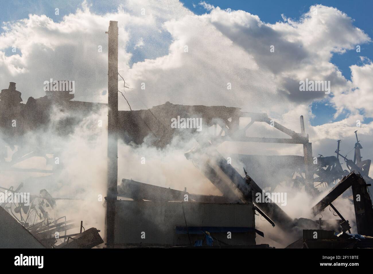 Technological disaster, fire, destroyed industrial building, smoke and ...