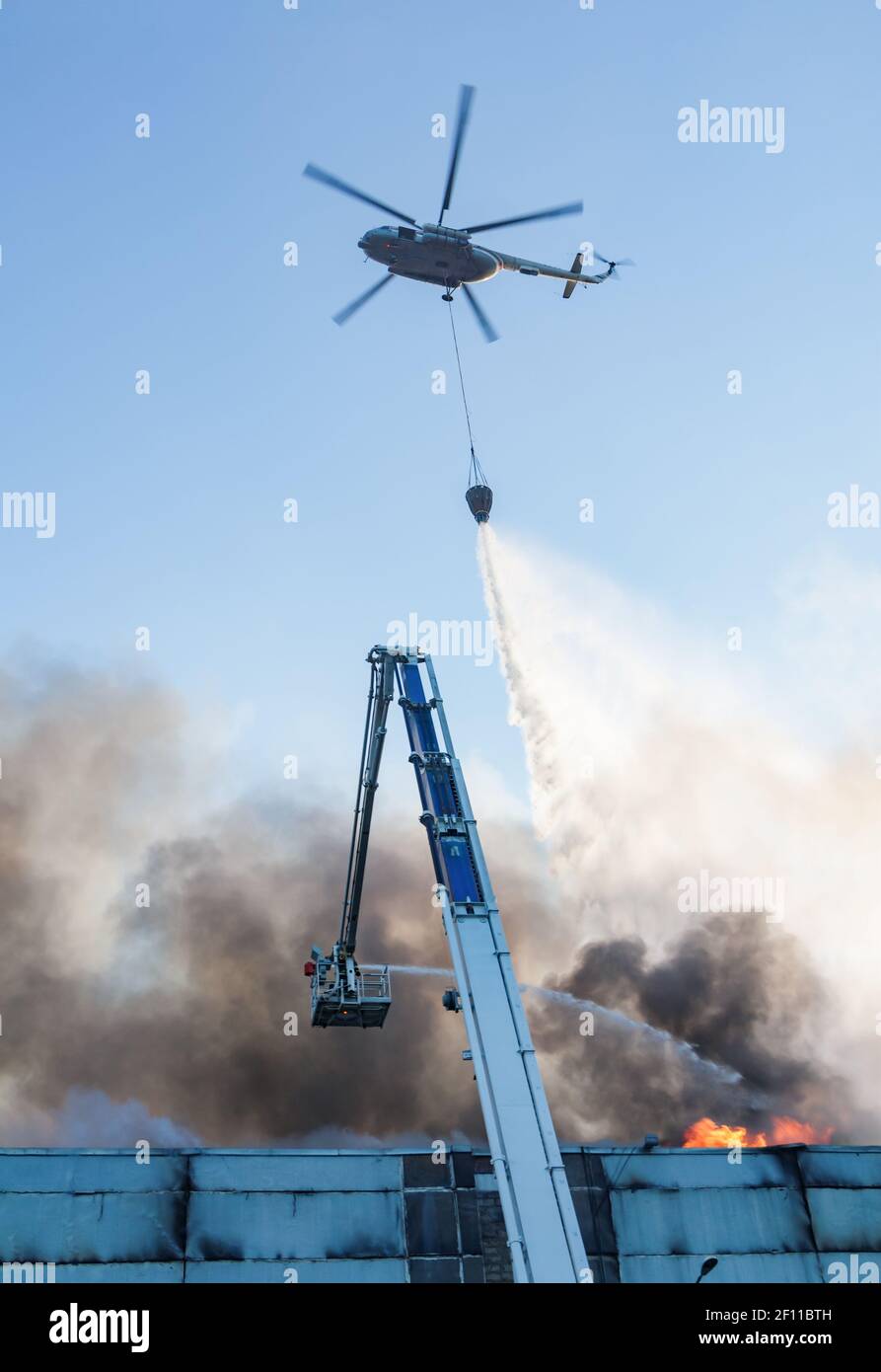 Firefighting in the city with the help of a helicopter and a fire ...
