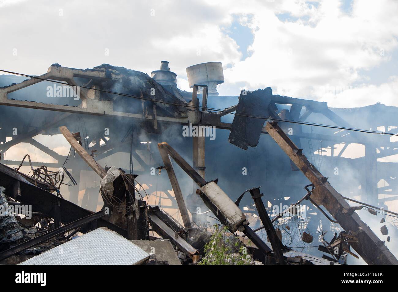 Technological disaster, fire, destroyed industrial building, smoke ...