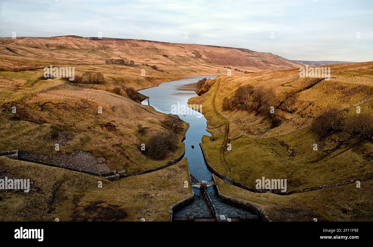 Looking down from the top of Angram reservoir dam to the spillway that ...