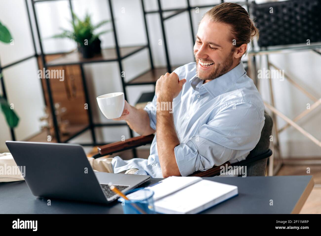Satisfied caucasian successful guy, freelancer or ceo, relaxes at ...