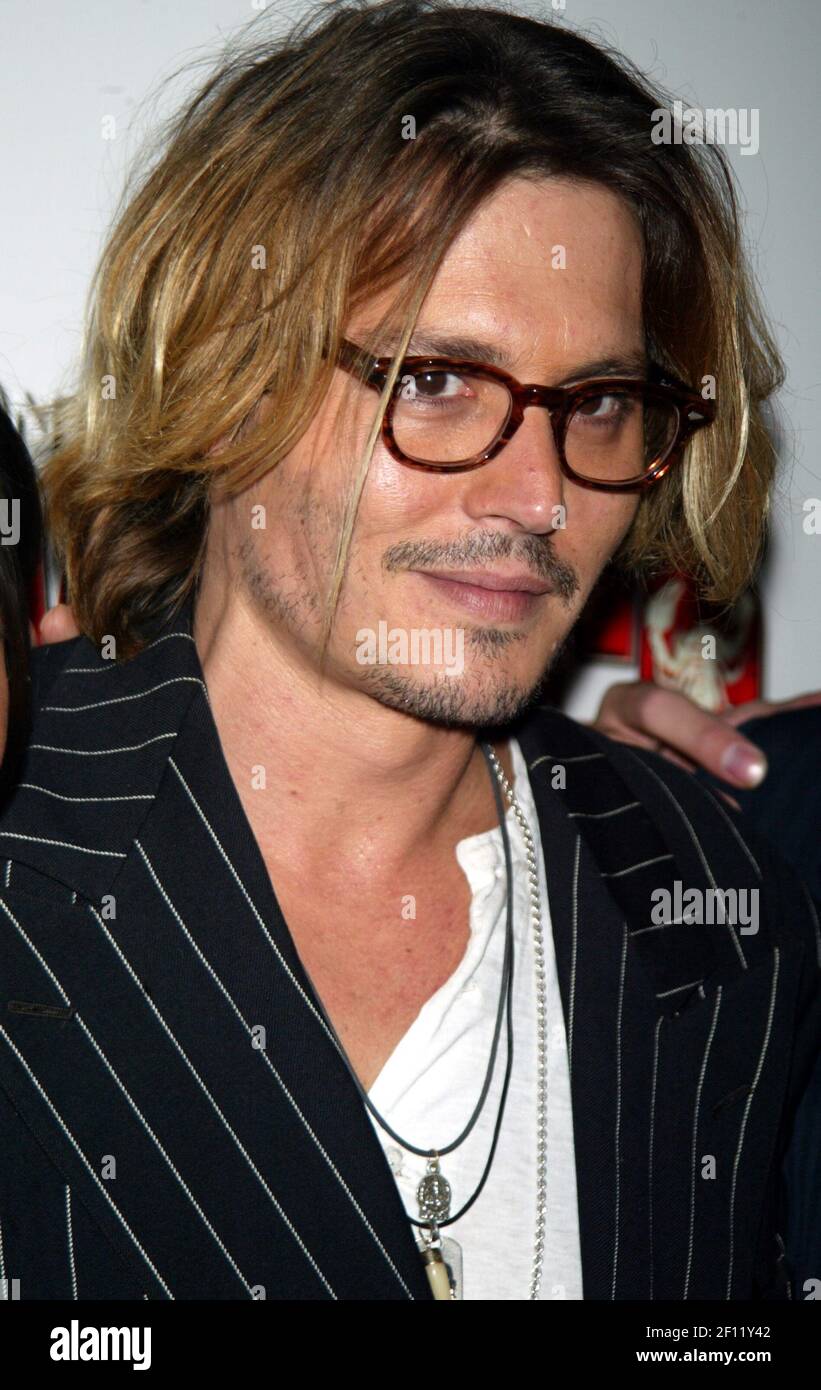 Johnny Depp poses for pictures at the premiere of his new movie "Once ...
