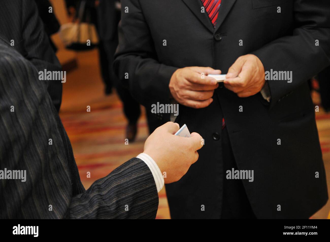 Chinese workers exchanging name cards in one of the Beijing CBD towers ...