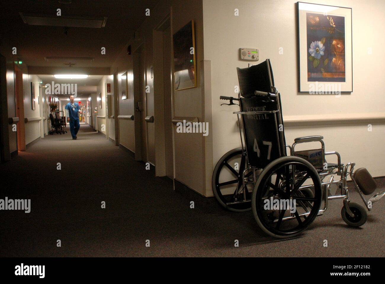 On an evening shift, R.N. Eric Umandap walks a corridor at Allenmore ...