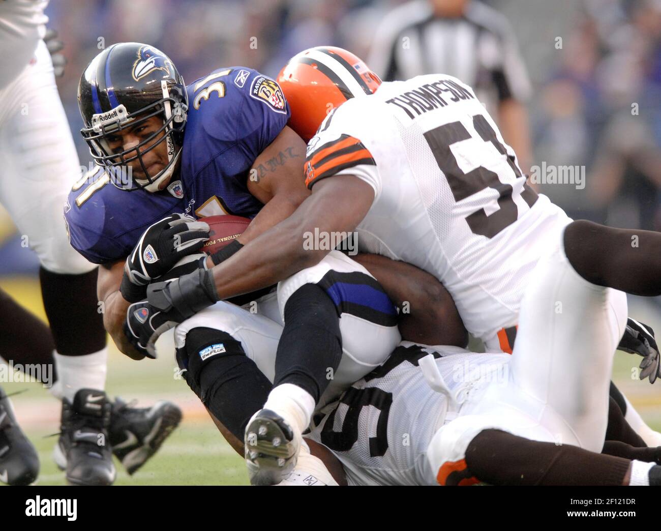 The Baltimore Ravens' Jamal Lewis is brought down by the Cleveland ...