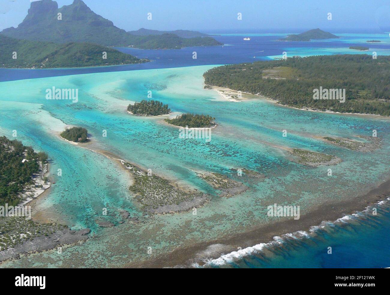 The coastline of Bora Bora has a variety of colors from the sea in ...