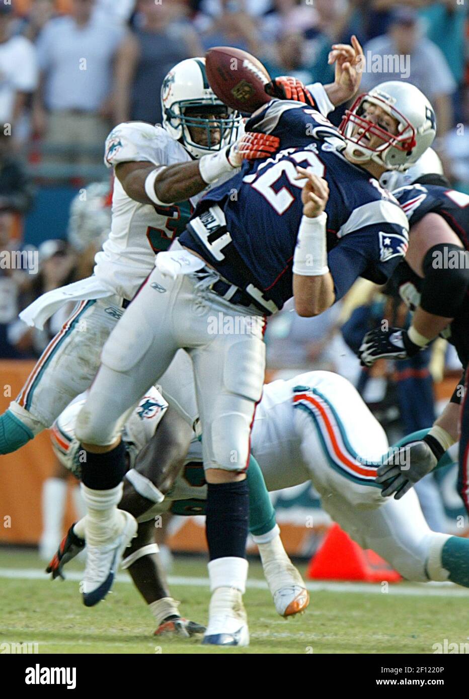 New England Patriots quarterback Tom Brady gets hits by Miami Dolphins ...