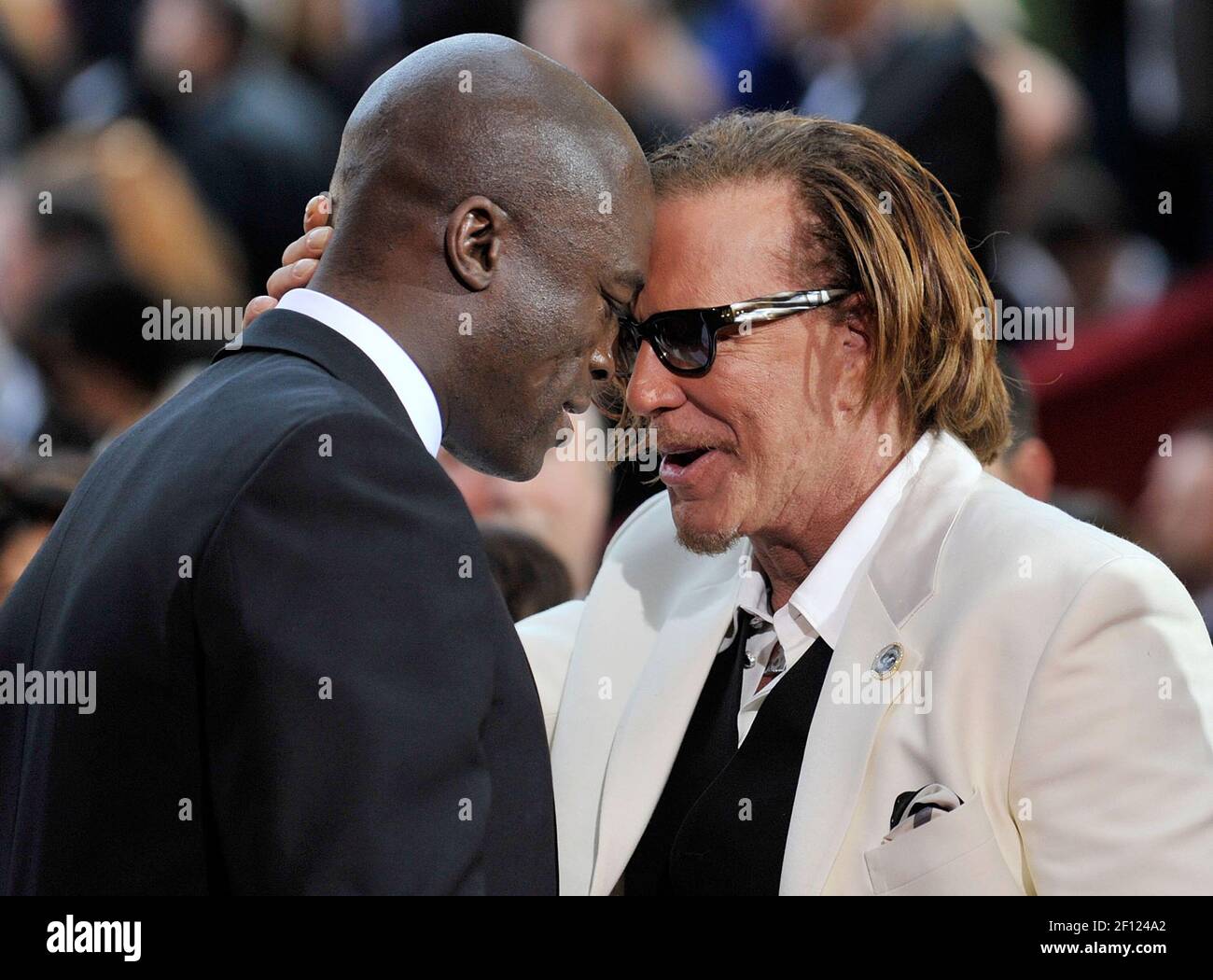 Seal and nominee Mickey Rourke share a moment on the red carpet as they ...