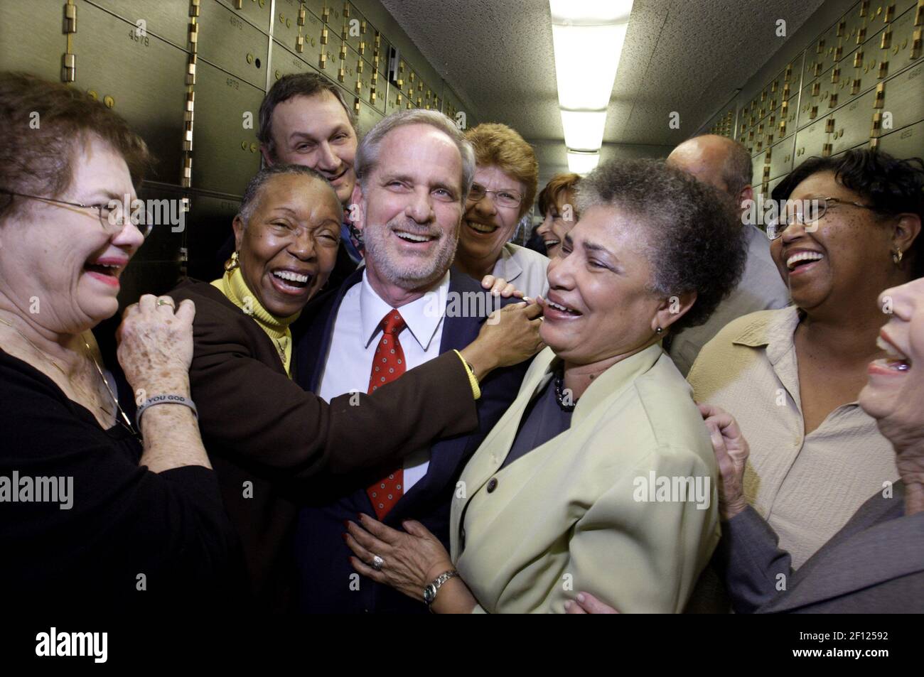 Leonard Abess Jr, CEO of City National Bank, center, is surrounded by ...