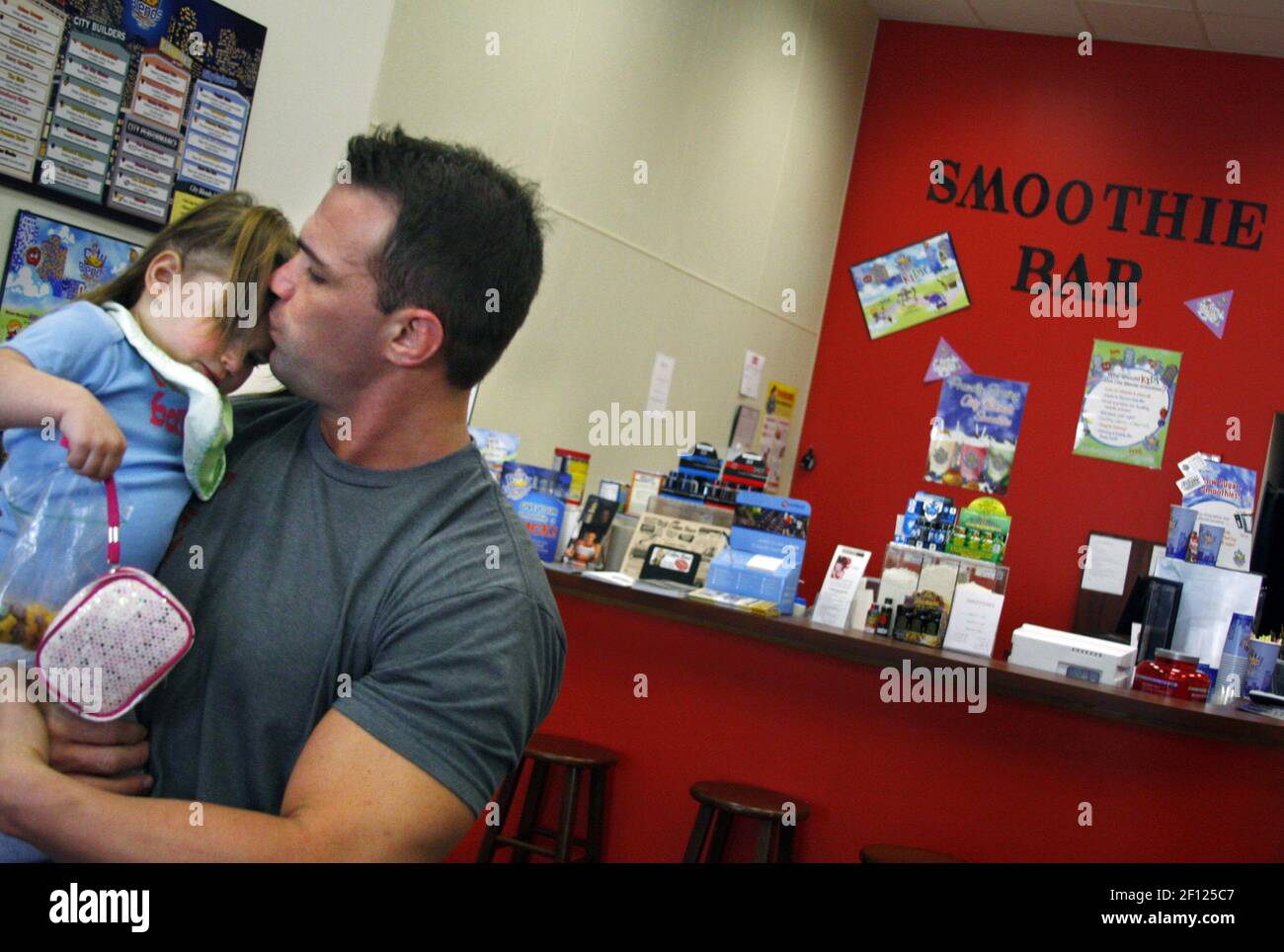 Professional wrestler Charlie Haas kisses his daughter, Kayla Haas, 2 ...