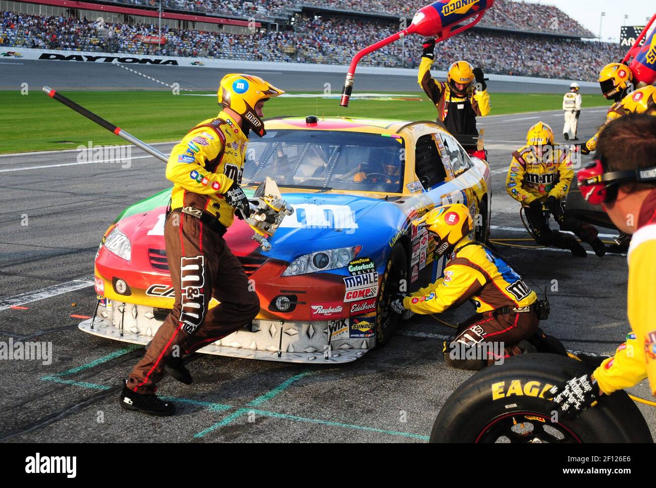 NASCAR driver Kyle Busch's pit crew hurry to change the tires and ...